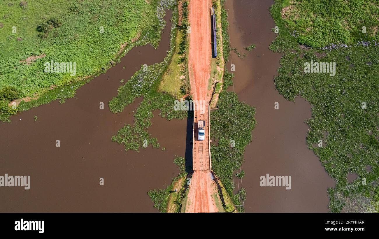 Close-up aerial view of a Pick up truck crossing a bridge over a lagoon ...