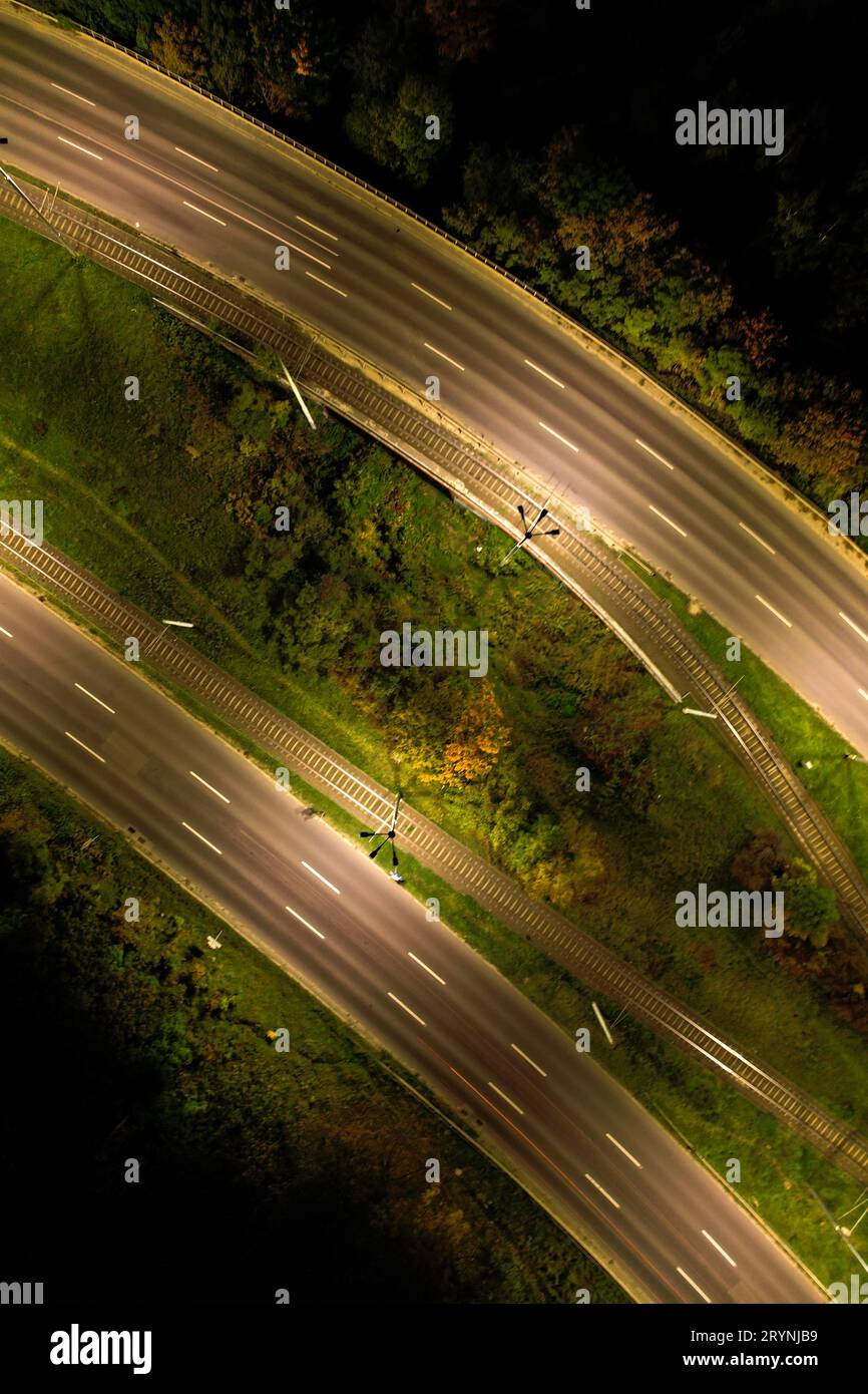Top down view to road. Romantic night aerial photo of cars traveling ...