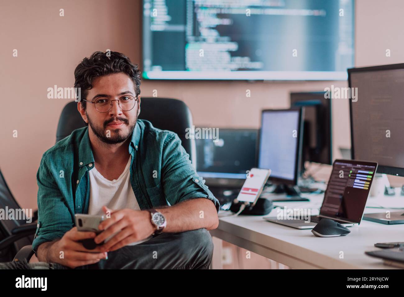 A programmer diligently testing smartphone applications while sitting ...