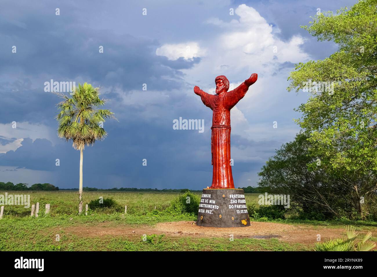 Red statue of Sao Francisco in a park against cloudy sky, Pantanal ...