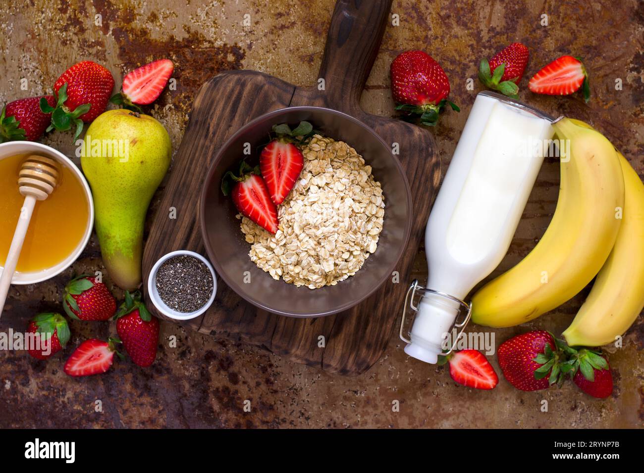 Healthy breakfast ingredients: Oatmeal, honey, fruit, strawberry Stock ...