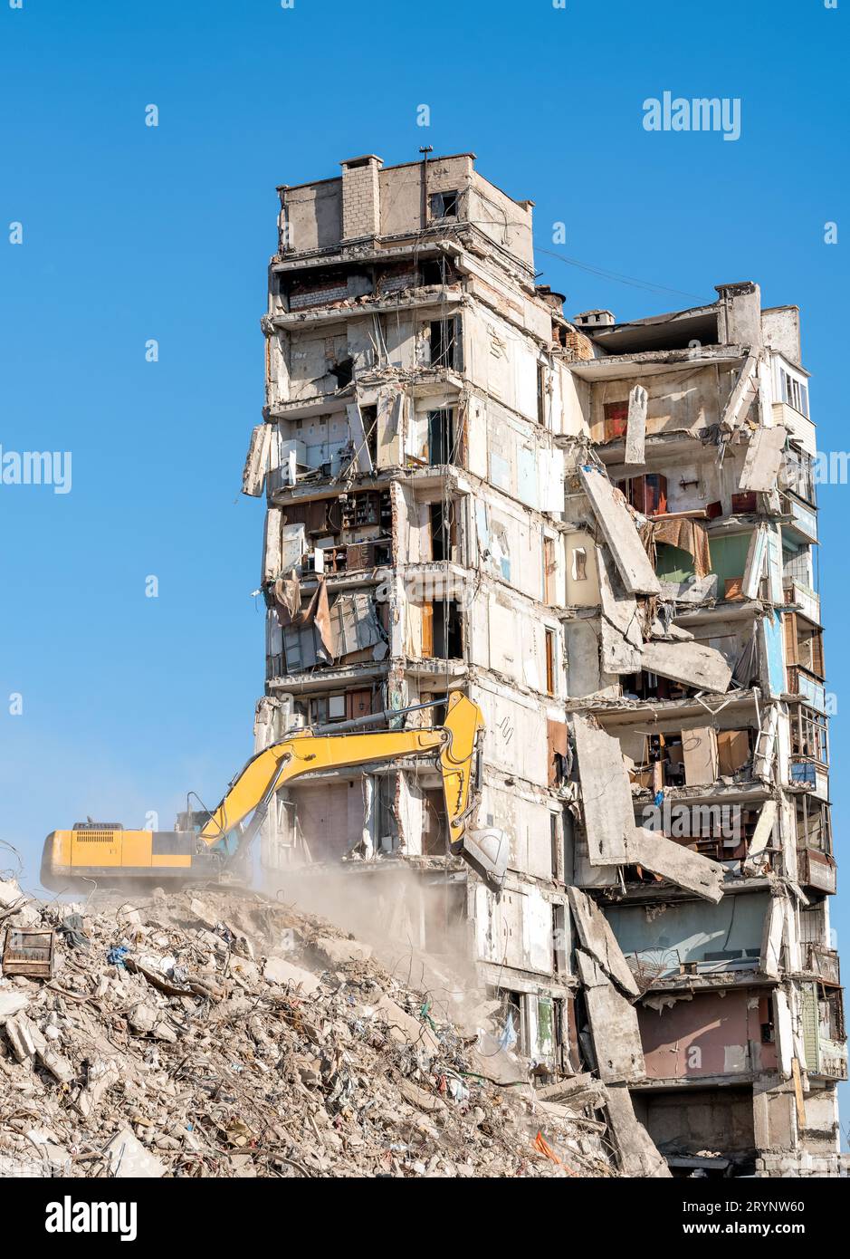 Construction equipment destroys houses damaged during the war in ...