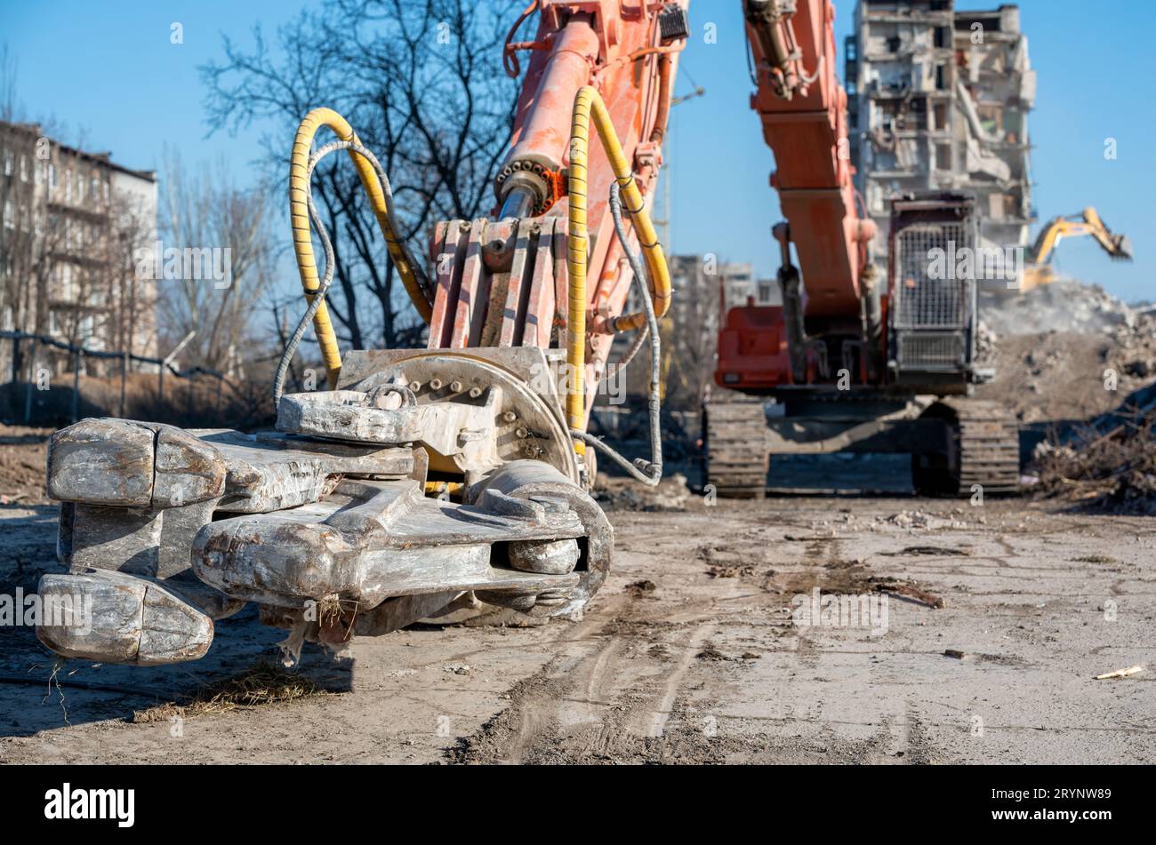 Construction equipment destroys houses damaged during the war in ...