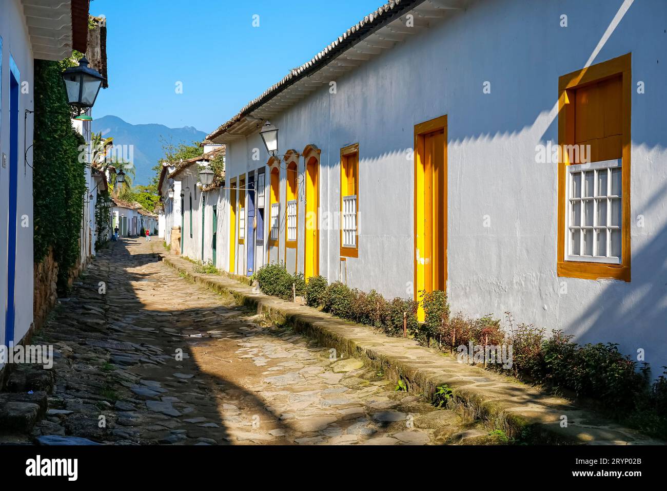 Typical cobblestone street with colorful colonial buildings in the late ...