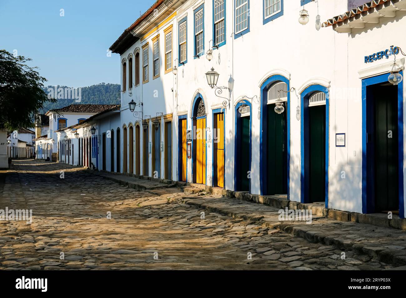 Typical cobblestone street with colonial buildings in afternoon light ...