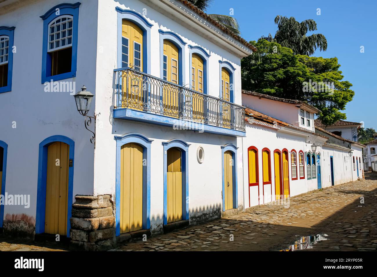 Typical colonial two and one story houses with colorful doors and ...