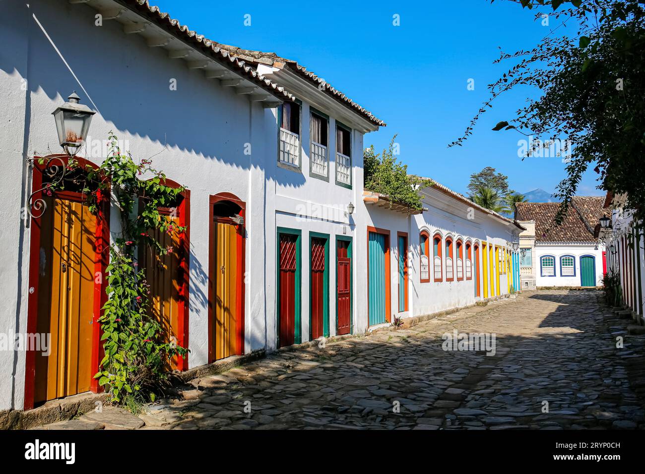 Typical cobblestone street with colorful colonial buildings in the late ...