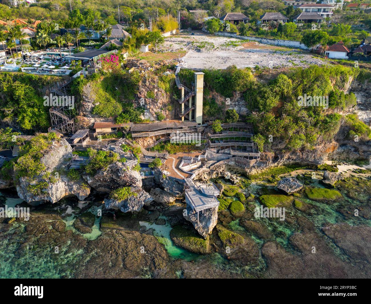 Aerial view of uluwatu cliff face in Bali, crystal clear water and blue ...