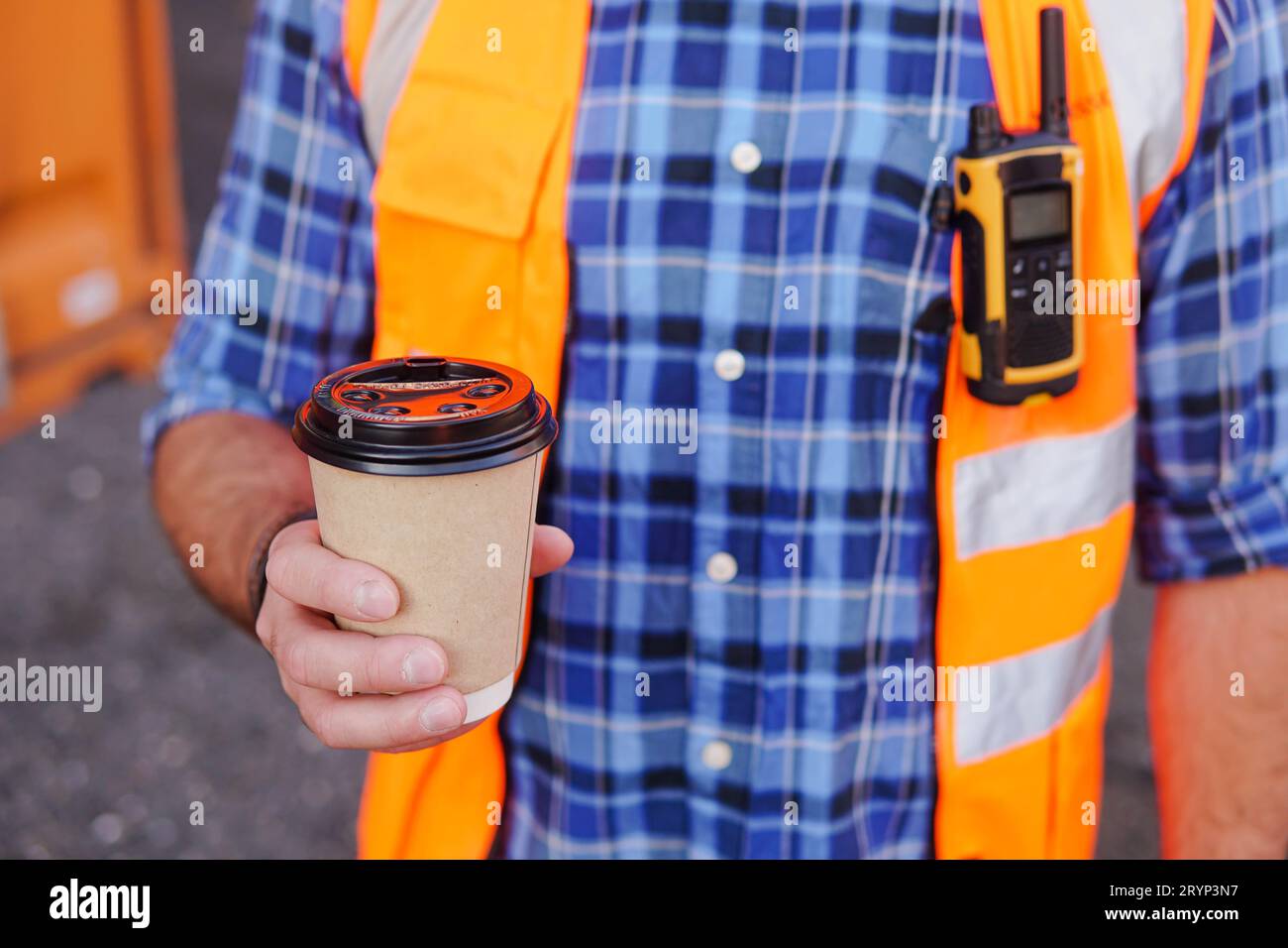 Young man engineer with coffee in container warehouse. Logistics ...