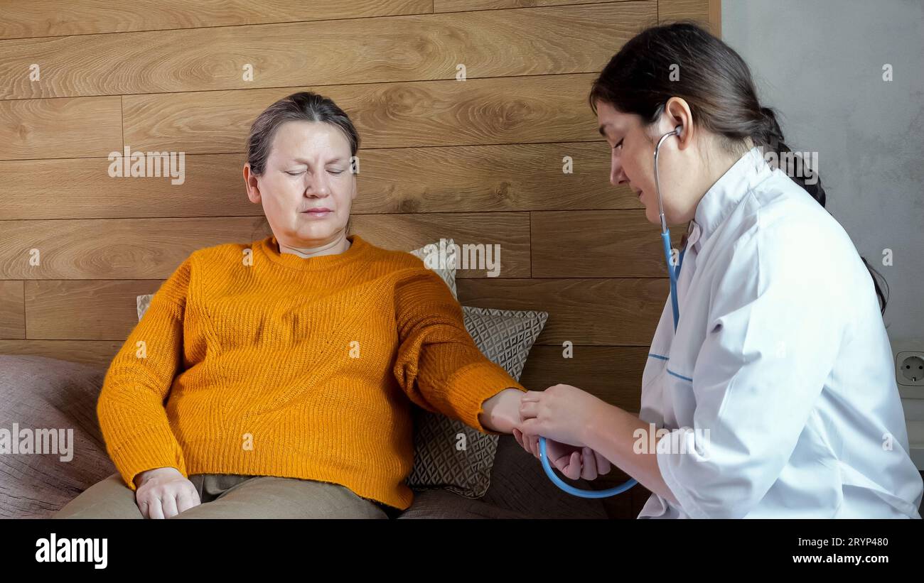 Professional nurse doing home check-up of senior woman Stock Photo - Alamy