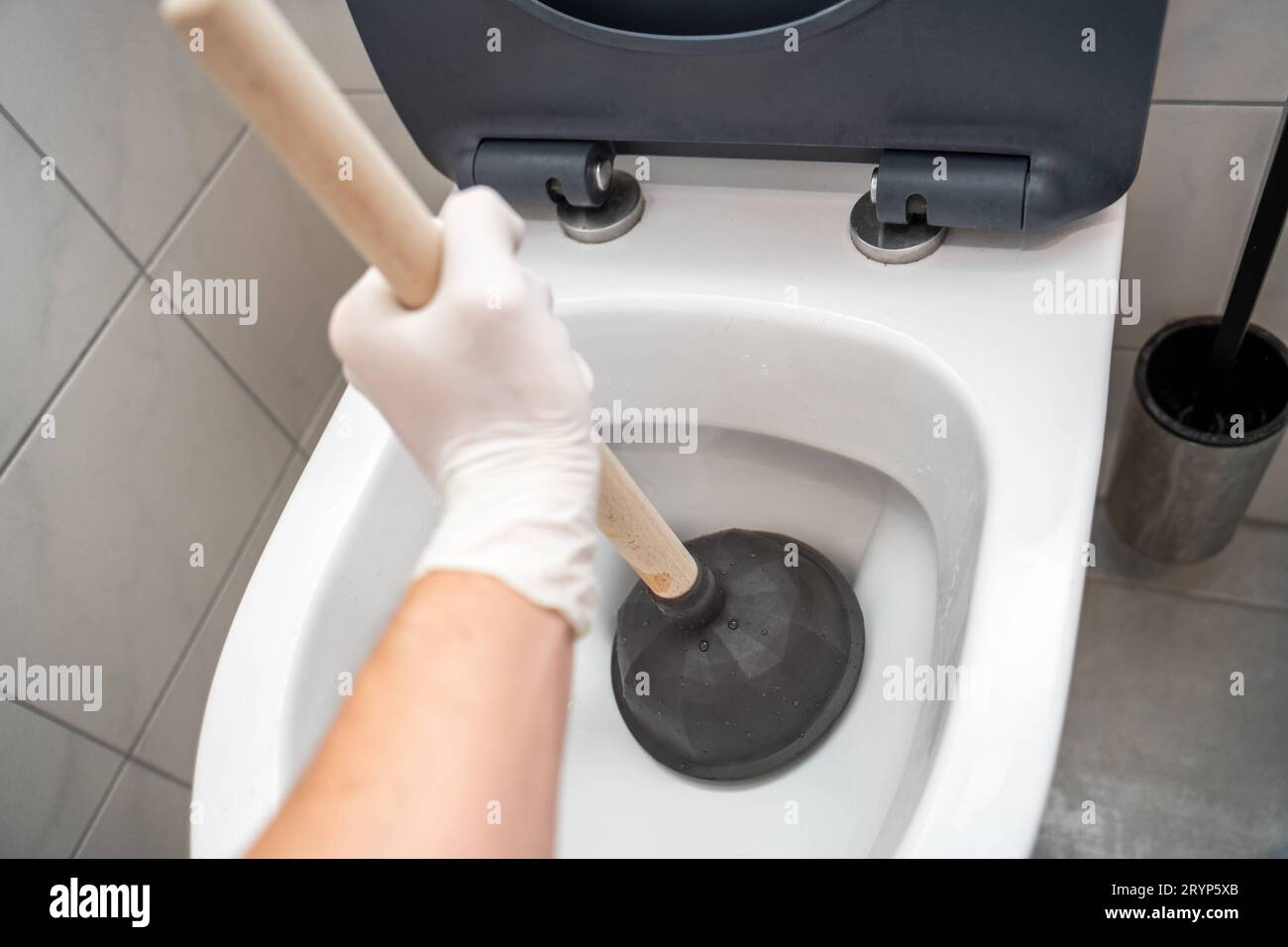 Bavaria, Germany. 29th Sep, 2023. Hand tries to unclog toilet in ...
