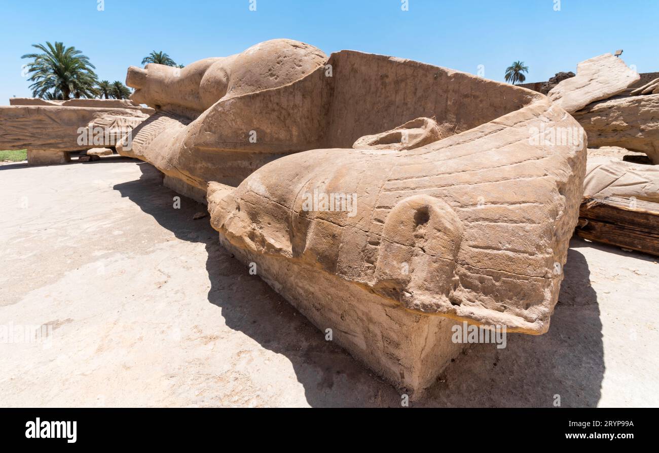 An ancient statue of Pharaoh lies on the ground in a Karnak temple in ...