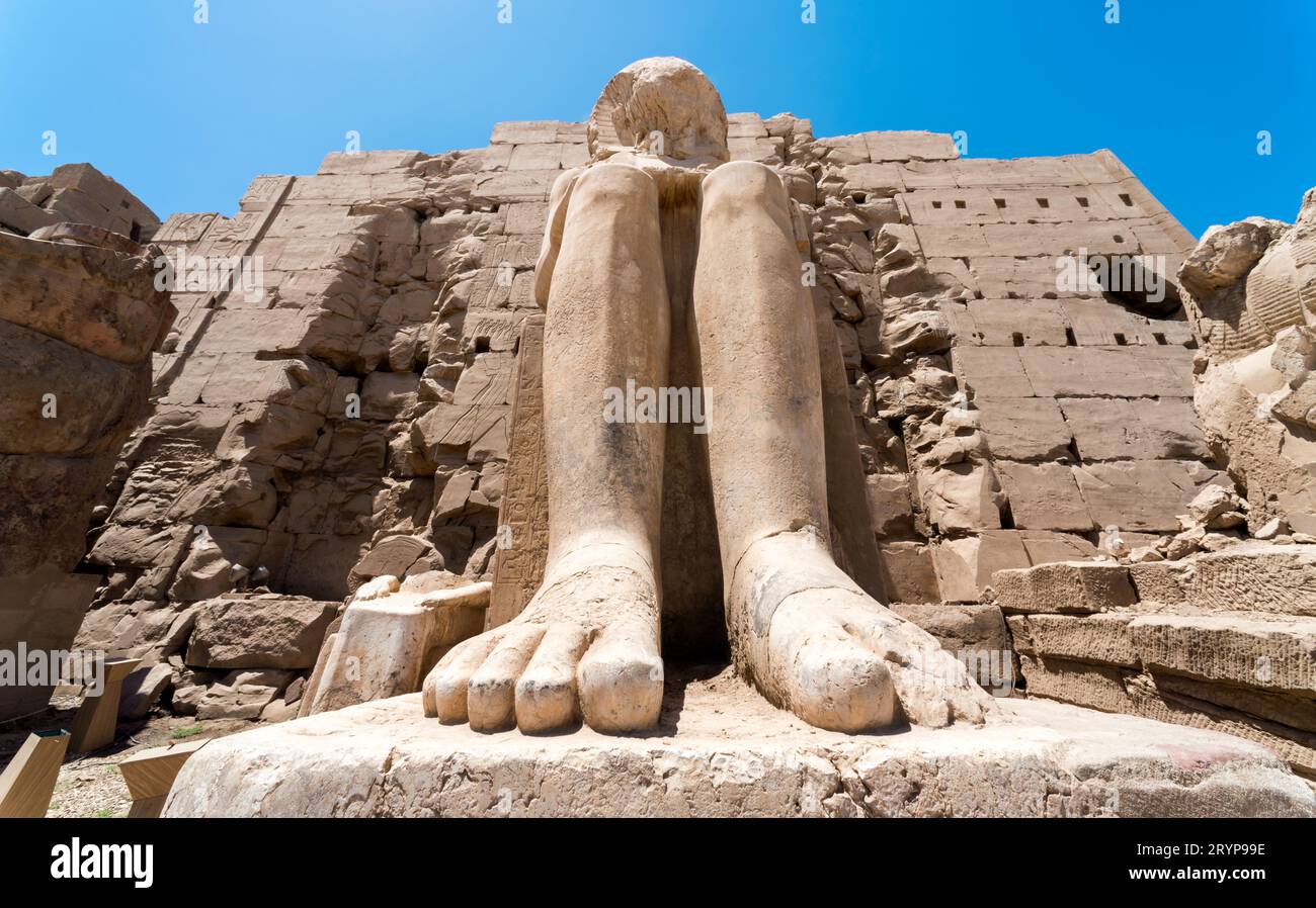 Feet of an ancient statue of Pharaoh in the Karnak temple in Luxor ...