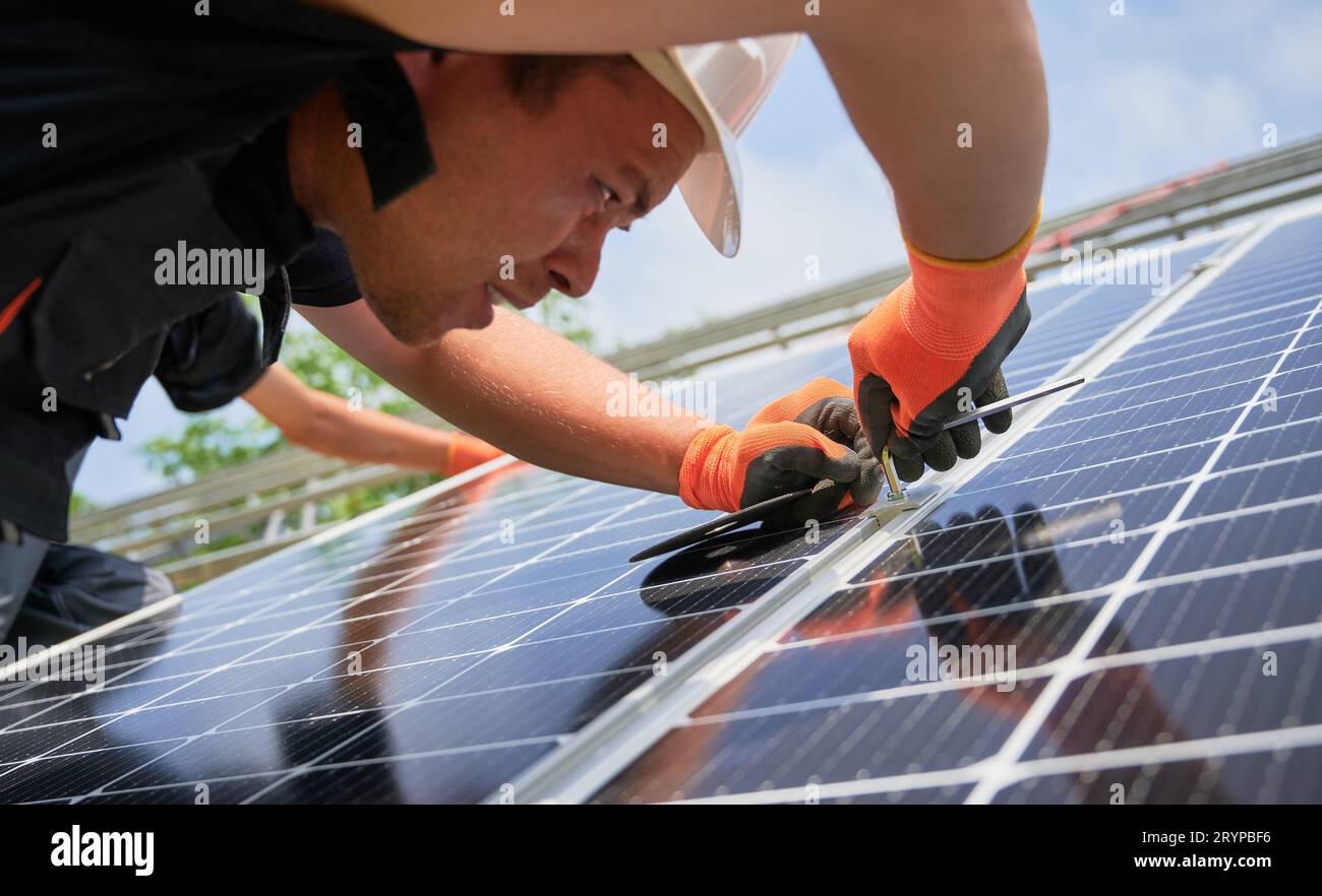 Technician working installing tightening solar hi-res stock photography ...