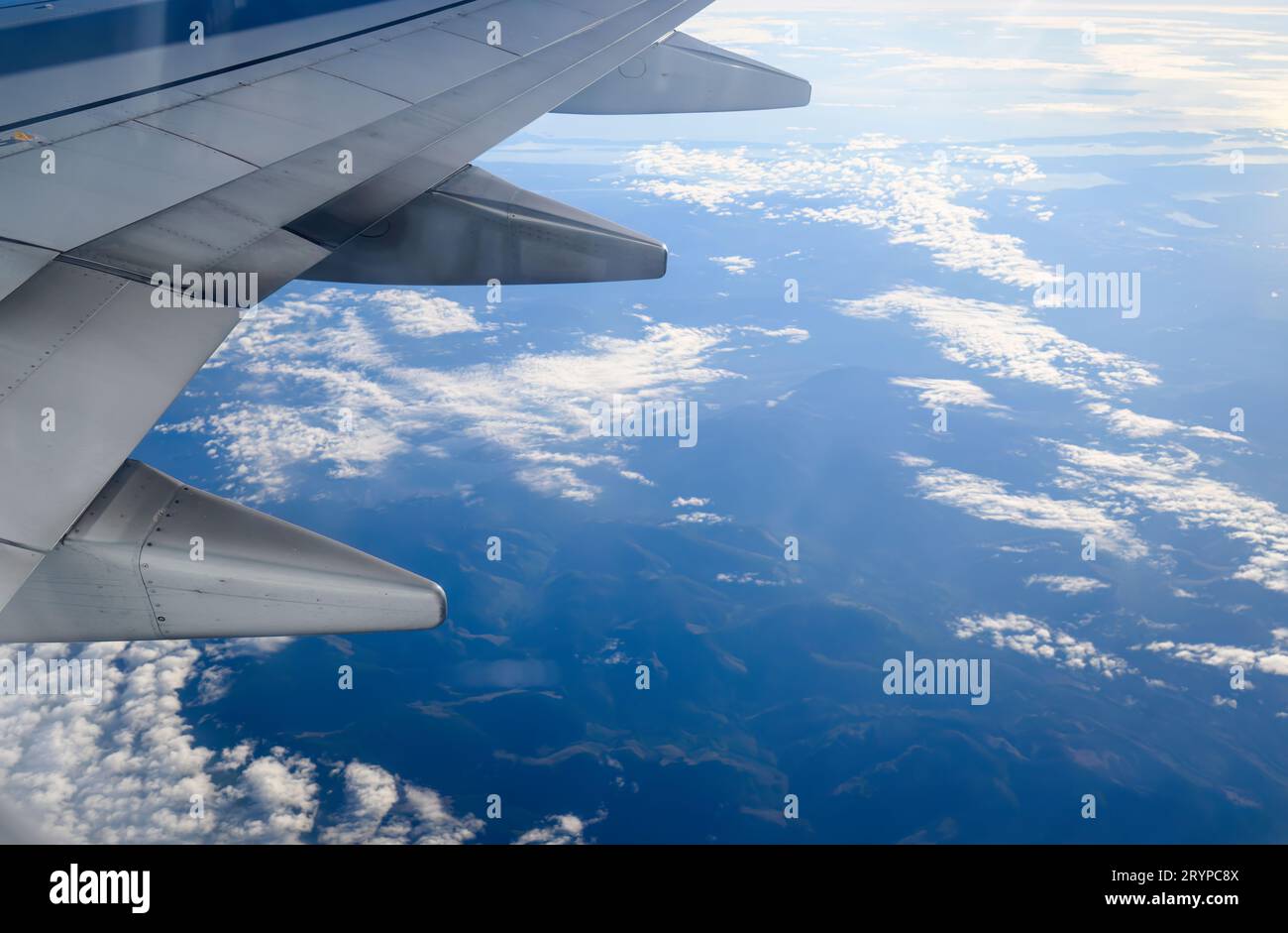 Aerial view of clouds over mountains. Airplane flight from Seattle to ...