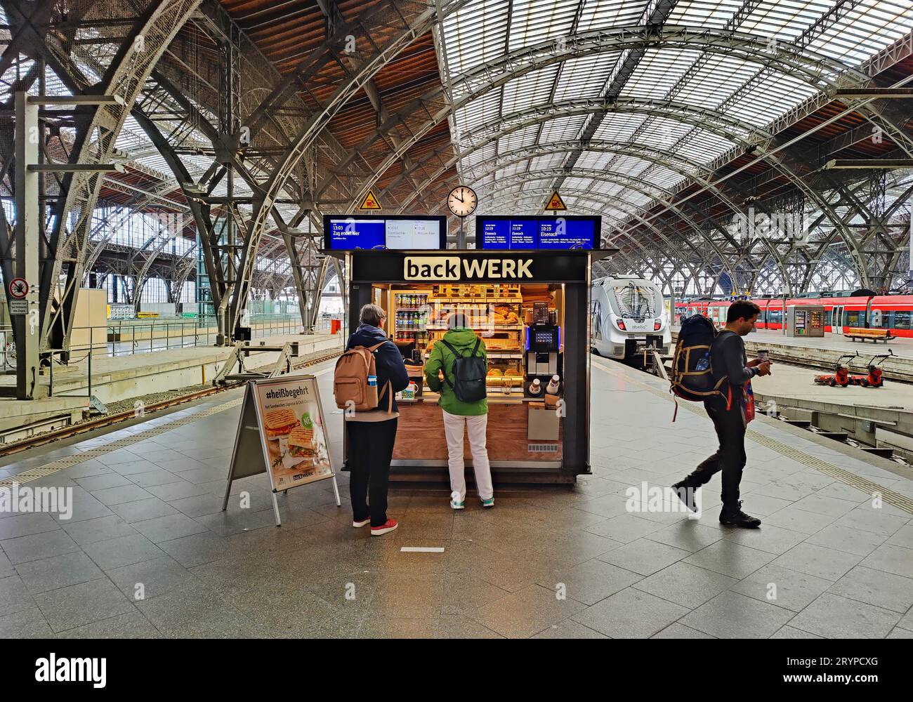 Stand selling baked goods between two train tracks in the main train ...