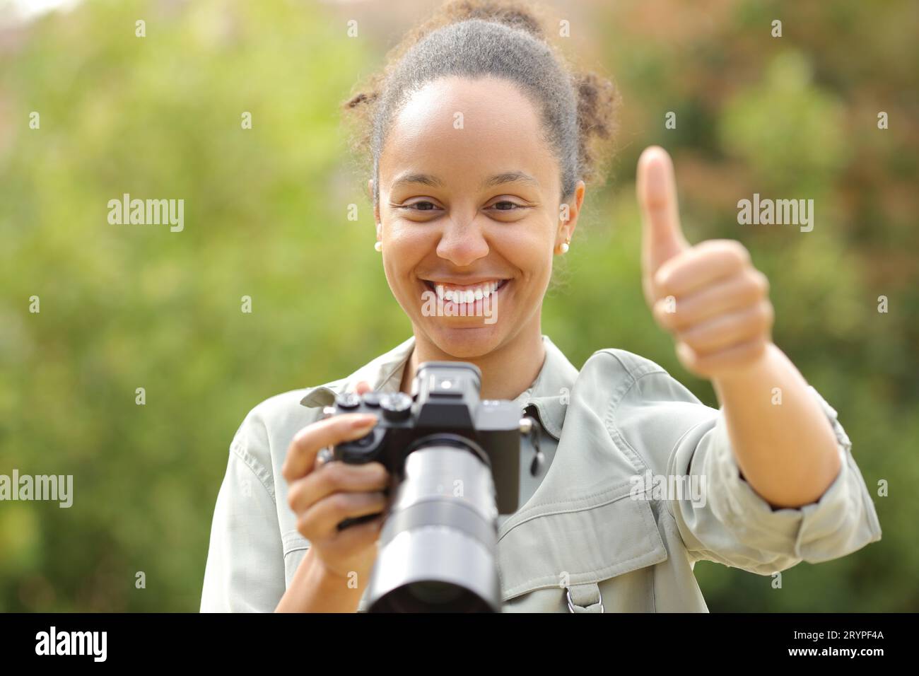 Front view portrait of a happy black photographer with thumbs up Stock ...