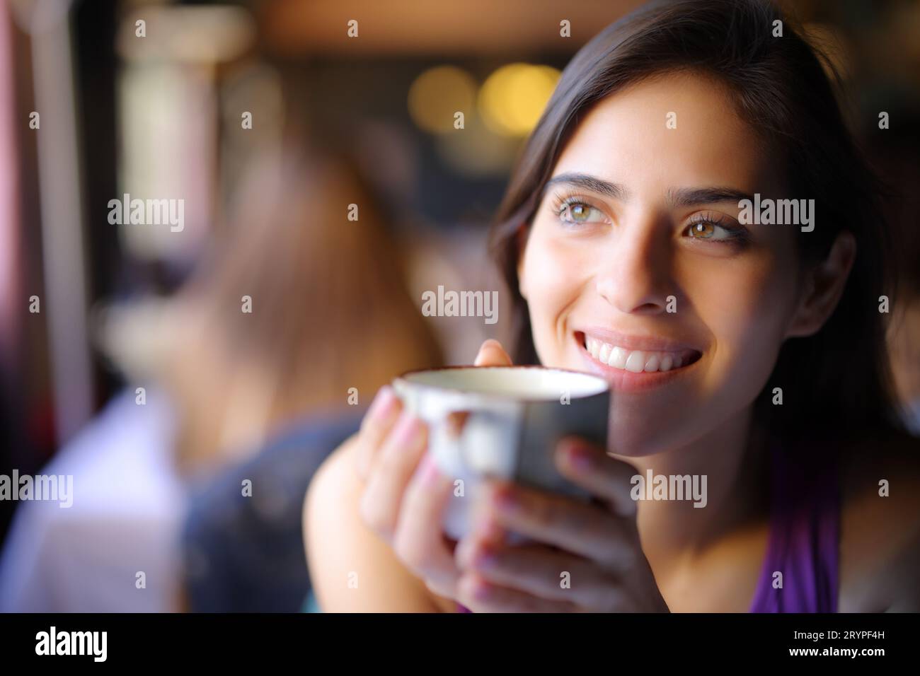 Happy dreamer dreaming drinking coffee in a restaurant interior Stock ...