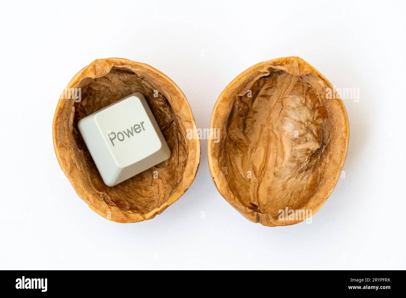Cracked walnut shell with a computer POWER button Stock Photo - Alamy