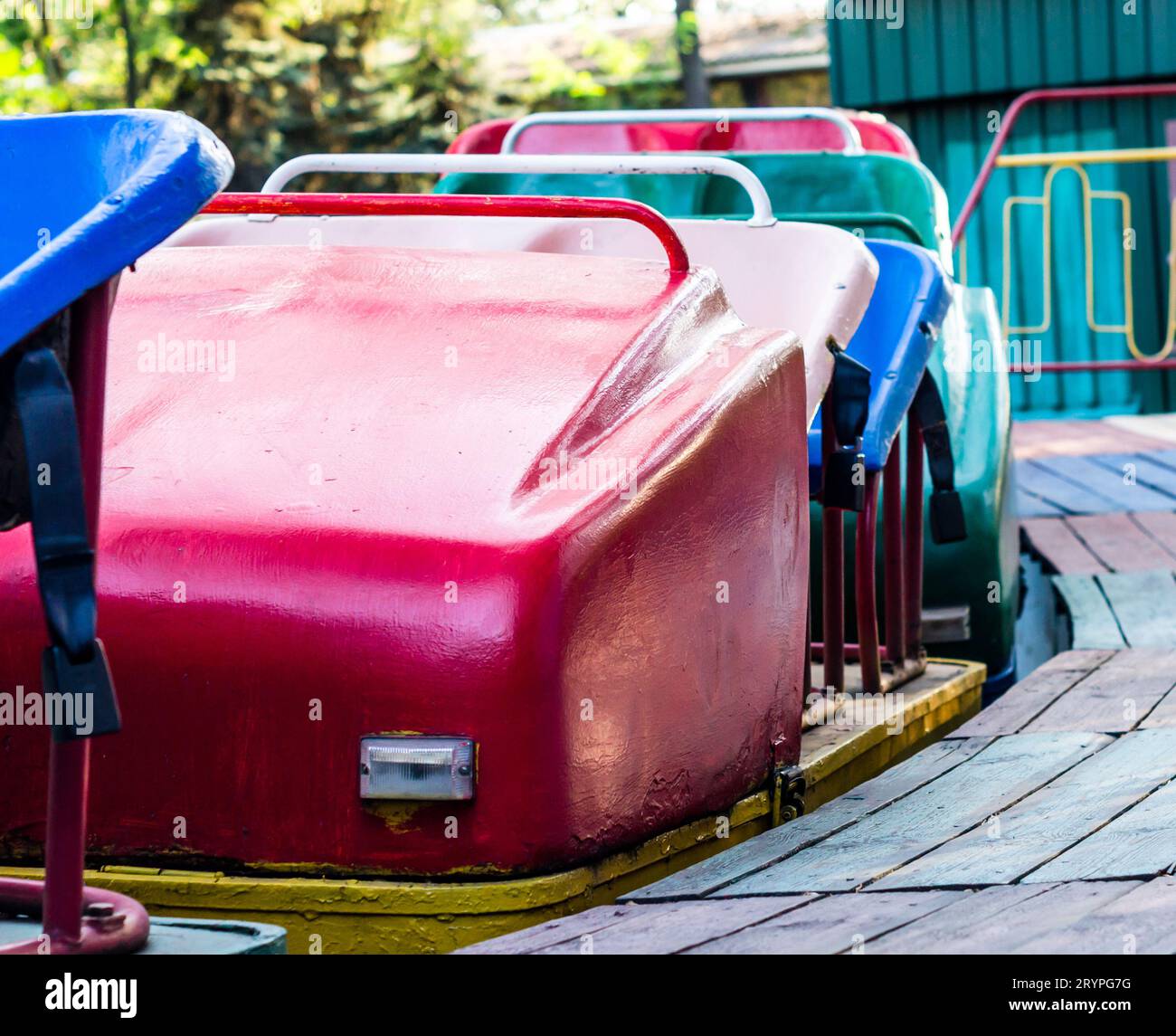 Old multi-colored attraction trailers american roller coaster in ...