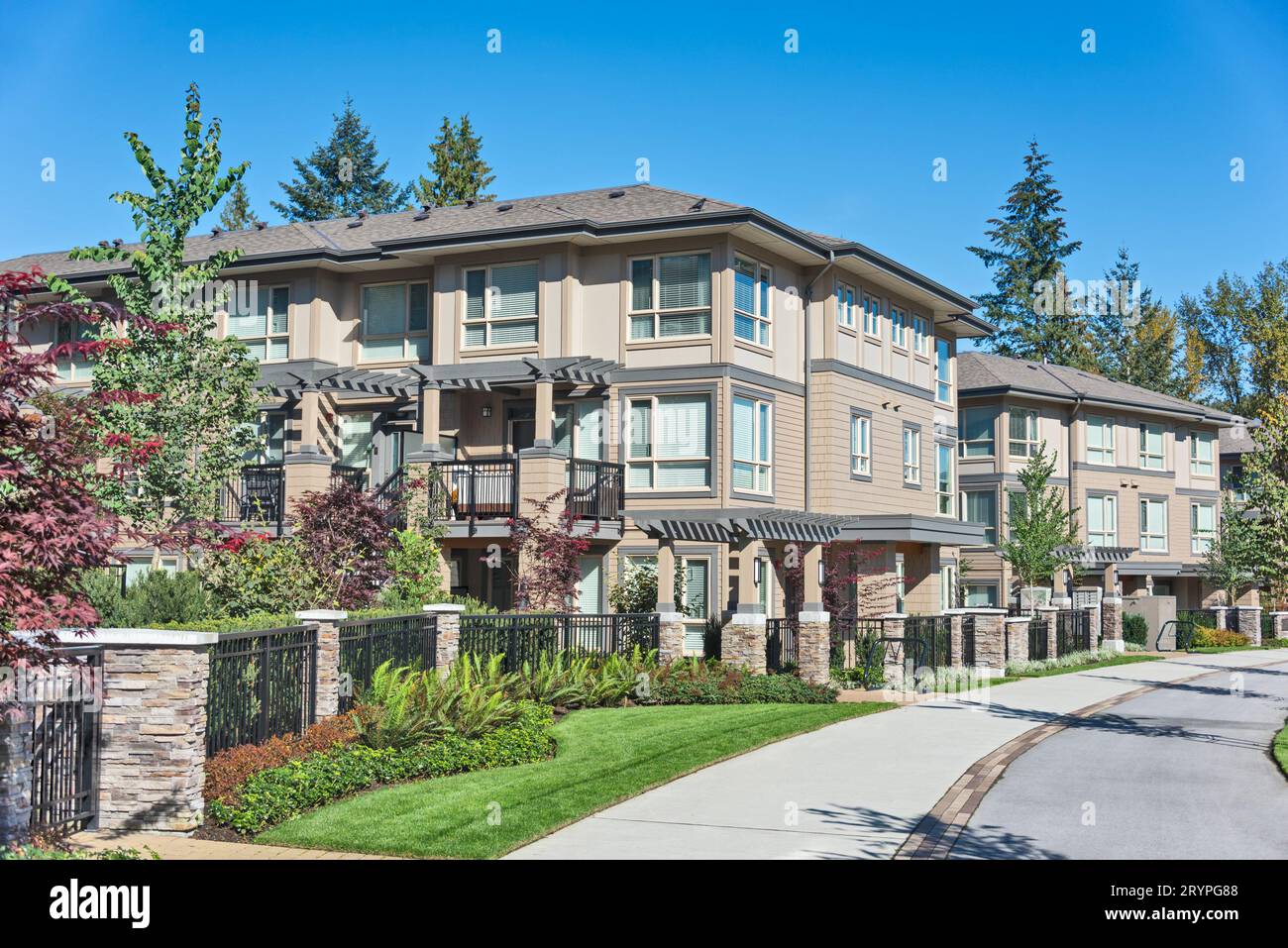 Paved pathway along residential building on sunny day Stock Photo - Alamy