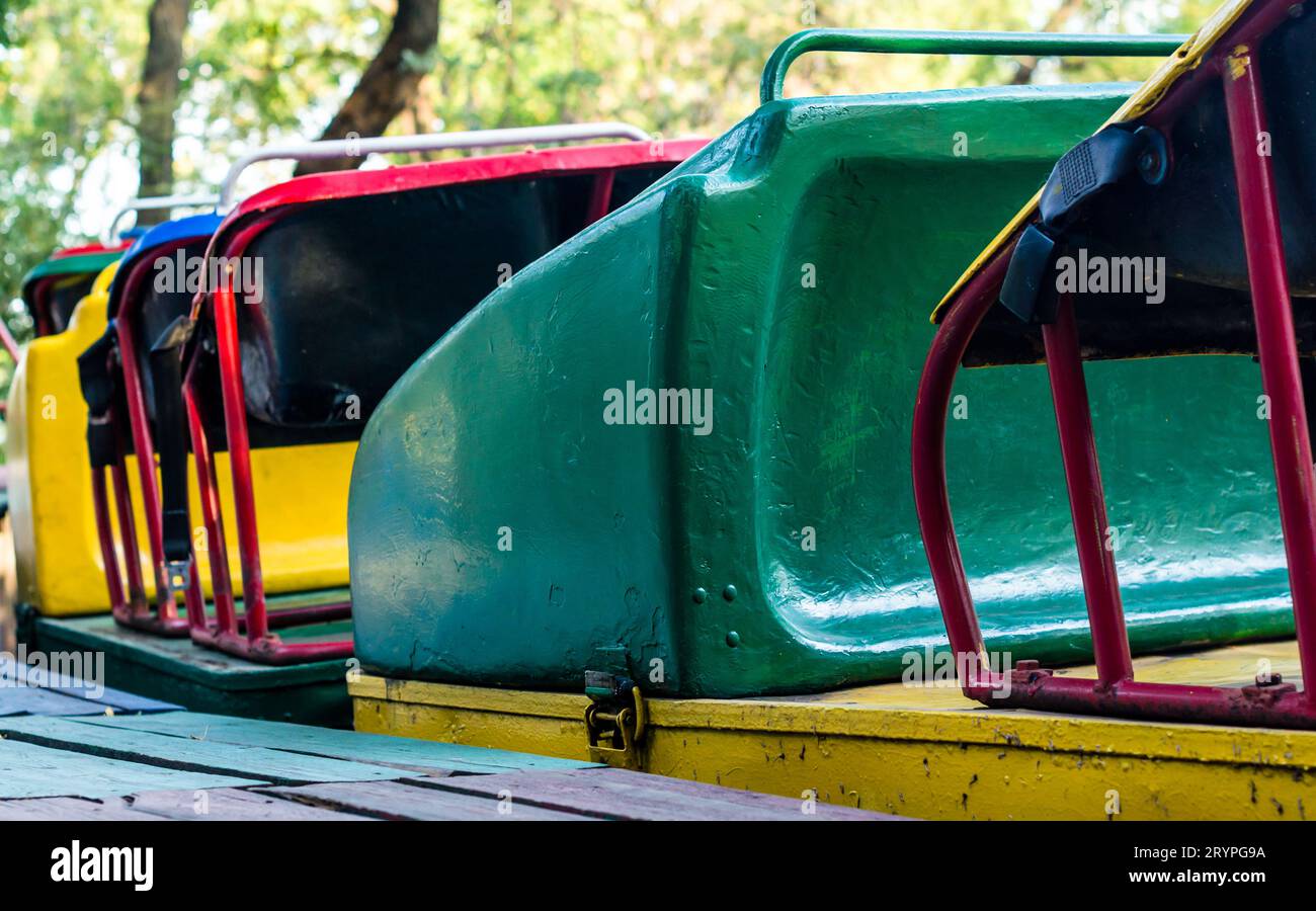 Old multi-colored attraction trailers american roller coaster in ...
