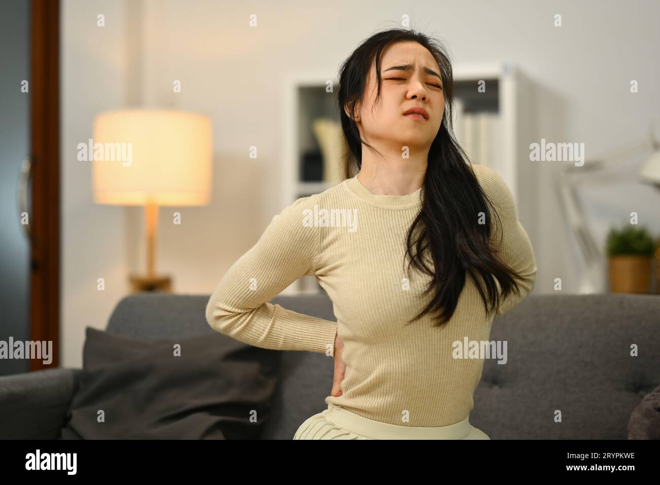 Unhappy young woman suffering from lower lumbar backache. Spine health ...