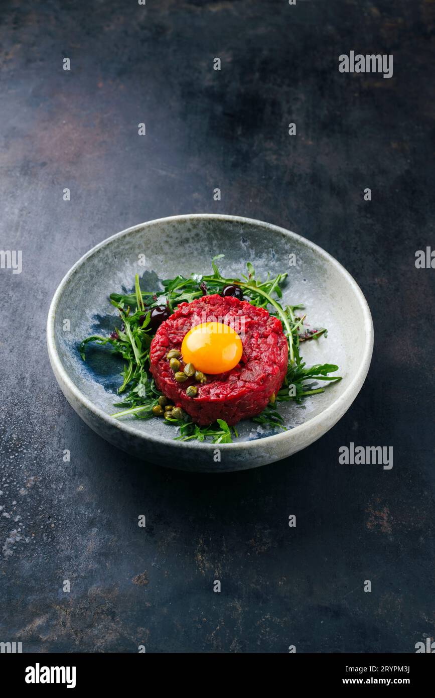 Modern style gourmet tartar raw from beef filet with egg Stock Photo ...