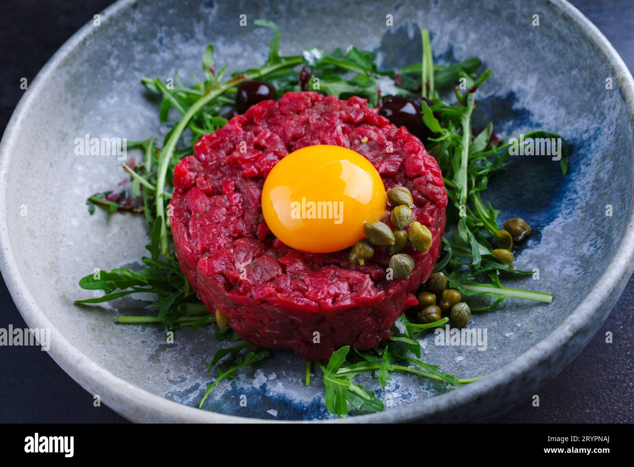 Modern style gourmet tartar raw from beef filet with egg Stock Photo ...