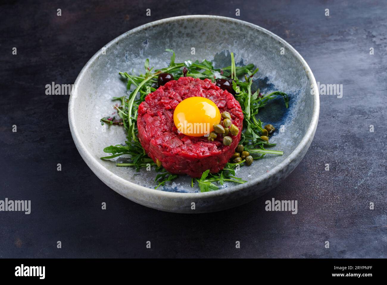 Modern style gourmet tartar raw from beef filet with egg Stock Photo ...