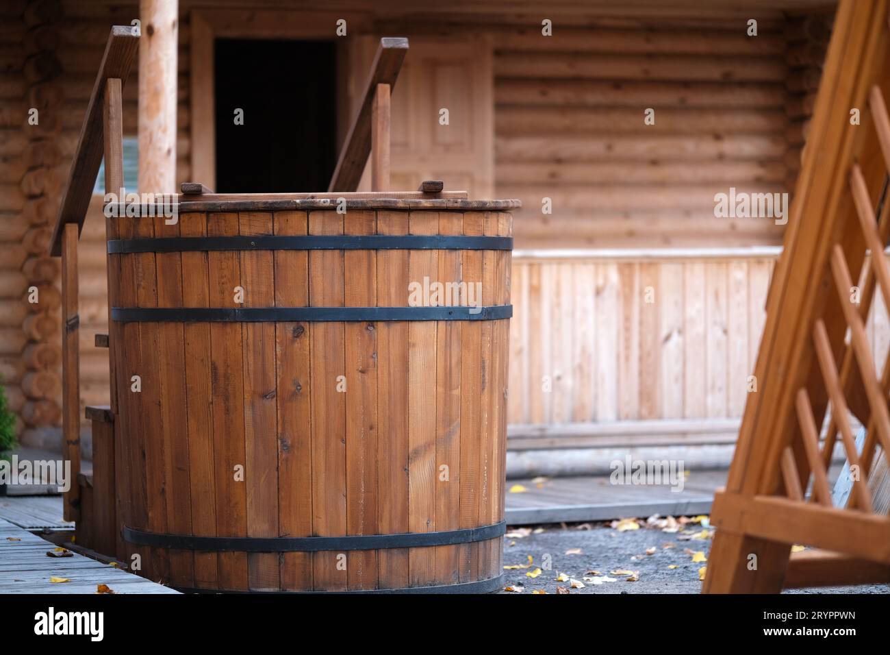 A barrel for dipping after an outdoor sauna. Barrel of water near the ...