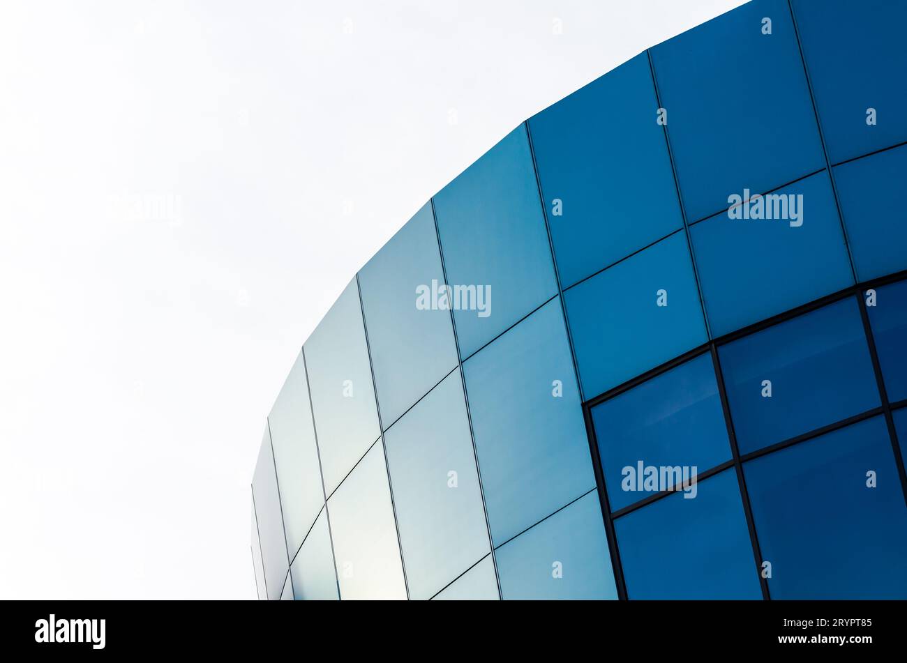 Facade of an office building with blue walls and mirrored windows Stock ...
