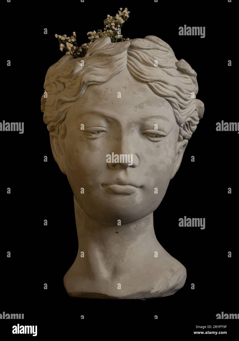 An elegant stone Greek statue of a female figure with a floral ...