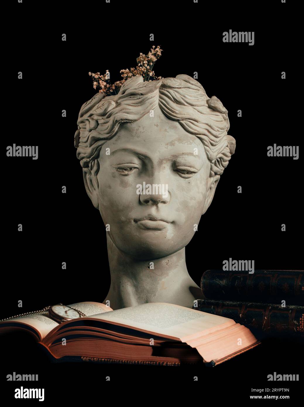 A stone Greek statue of a female with flowers on the head and a book in ...