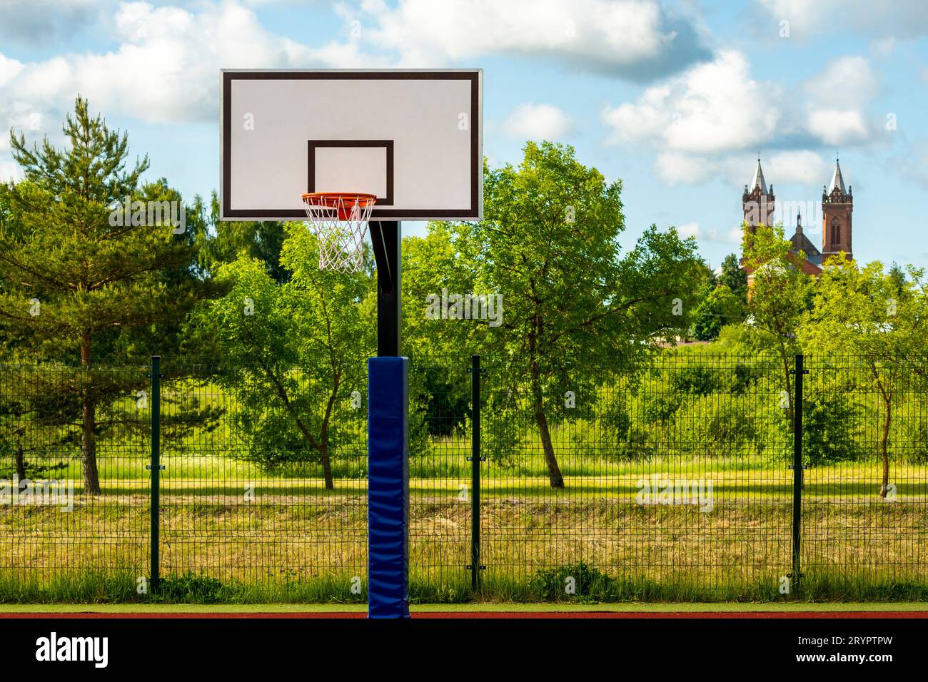 An outdoor community basketball court with a natural landscape Stock ...
