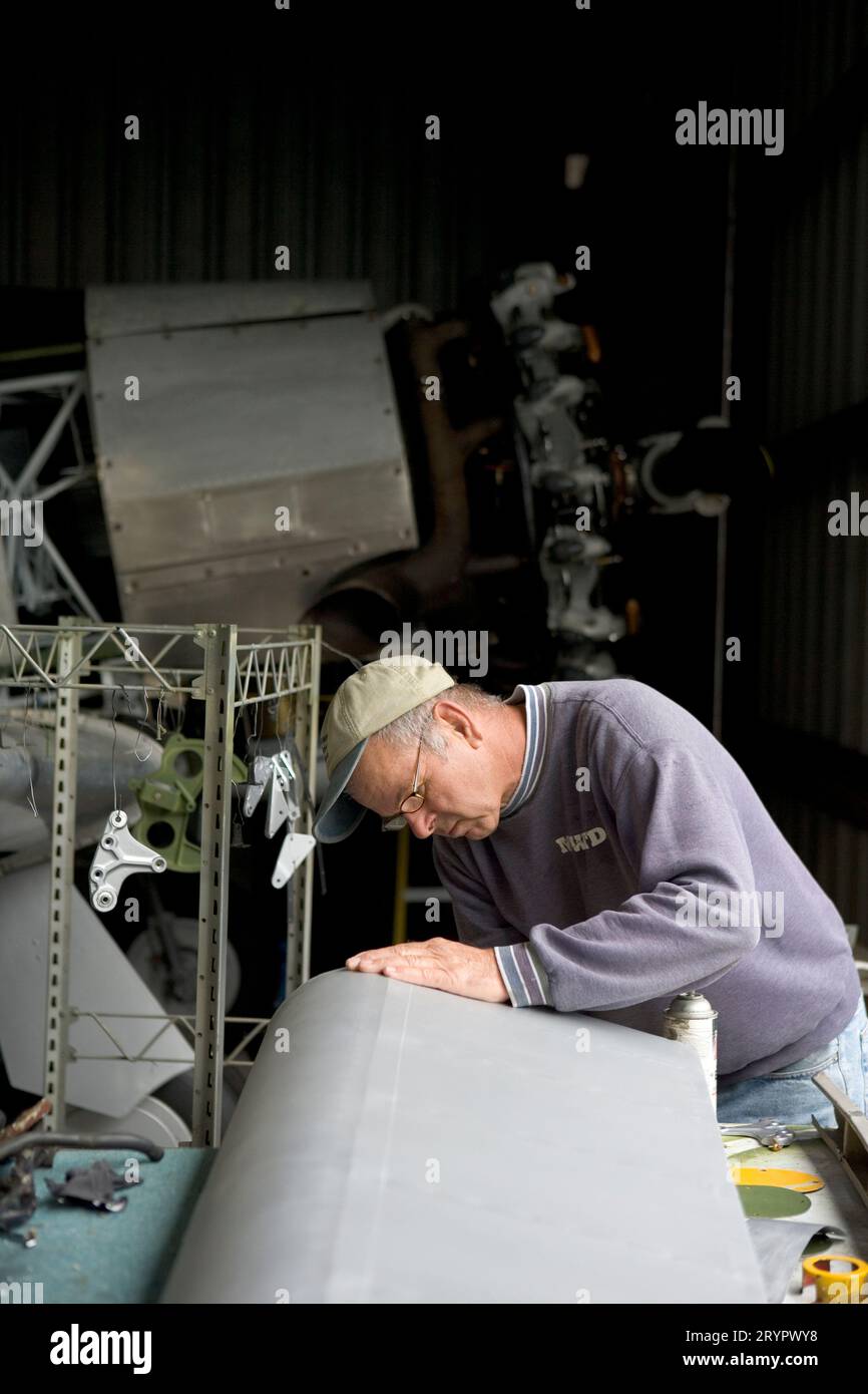 Airplane mechanic working on the wing of an airplane Stock Photo - Alamy