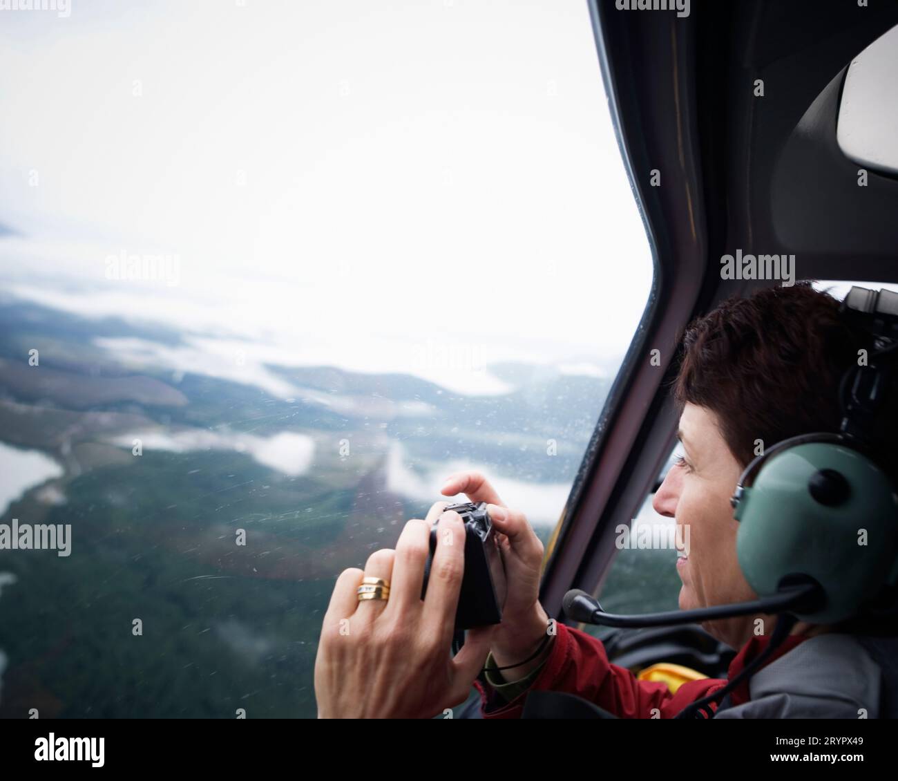 Woman photographing from helicopter hi-res stock photography and images ...