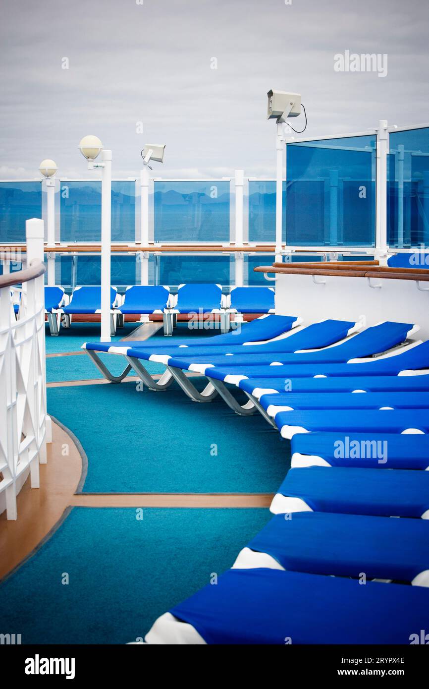 Deck lounge chairs in row on a cruise ship Stock Photo - Alamy