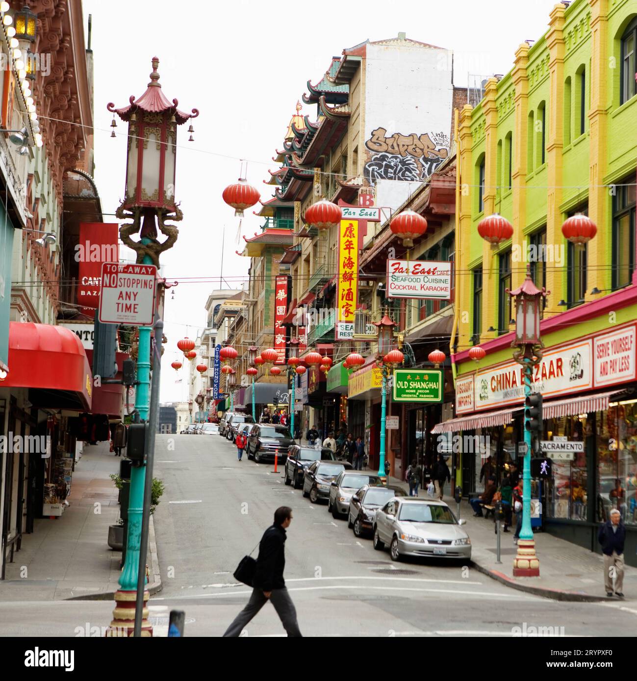A person walking across the Grant Avenue in the early mourning houses ...