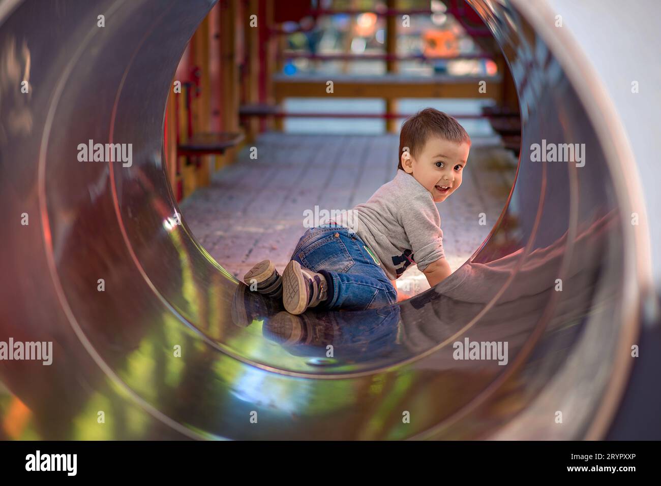 Cute little boy having fun on a slide at the playground Stock Photo - Alamy