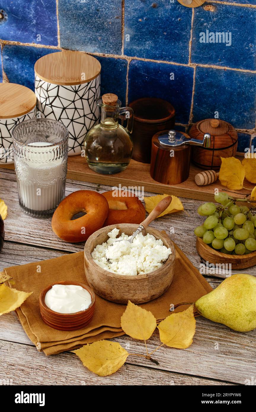 Still life in a rustic style: cottage cheese in a clay dish, mil Stock ...