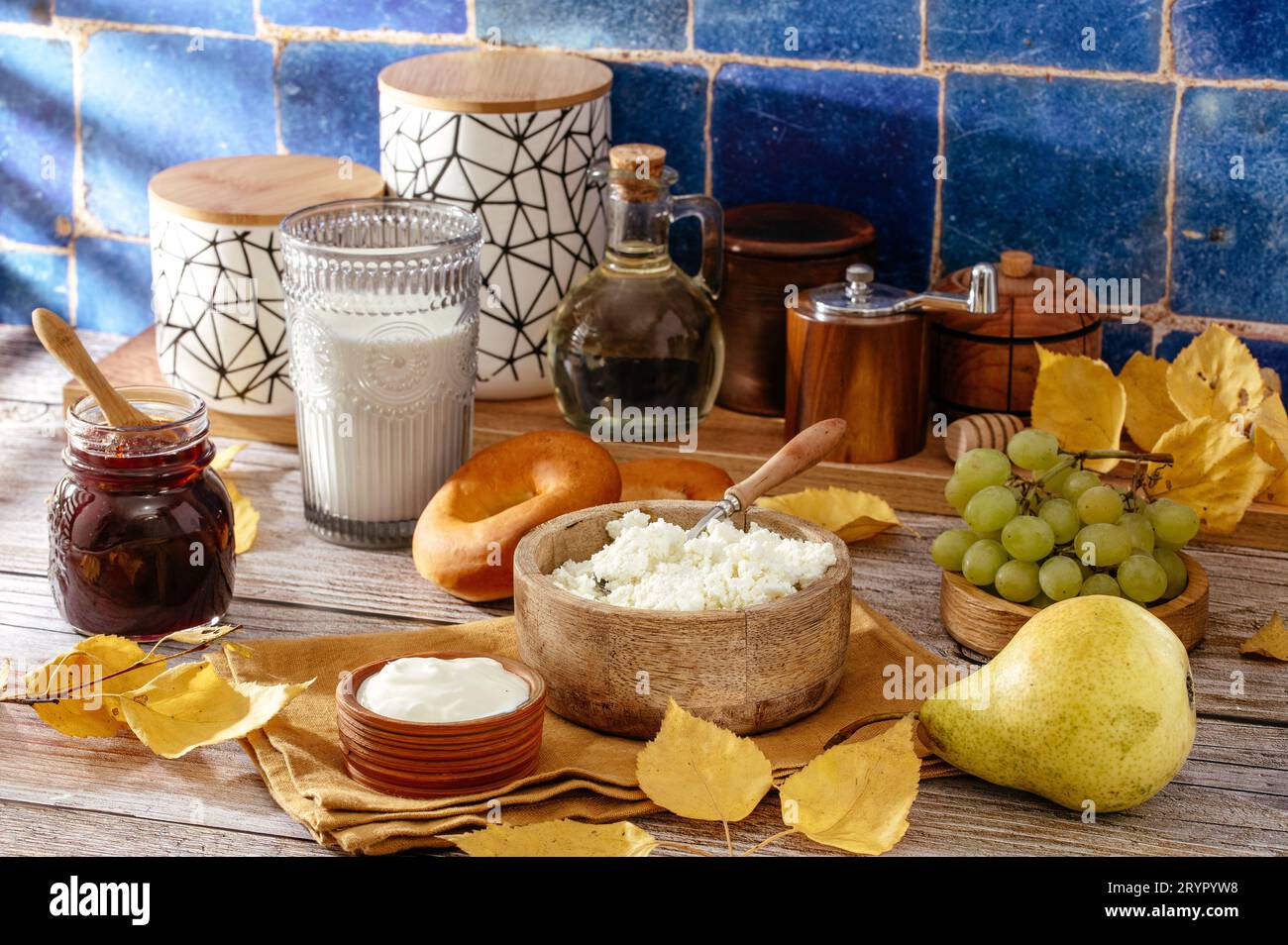 Still life in a rustic style: cottage cheese in a clay dish, mil Stock ...