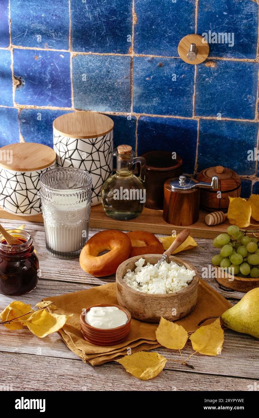 Still life in a rustic style: cottage cheese in a clay dish, mil Stock ...