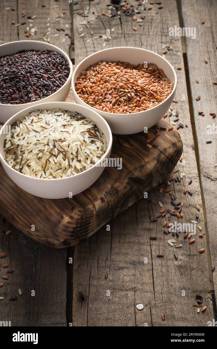 collection of different varieties of rice on wooden rustic background ...