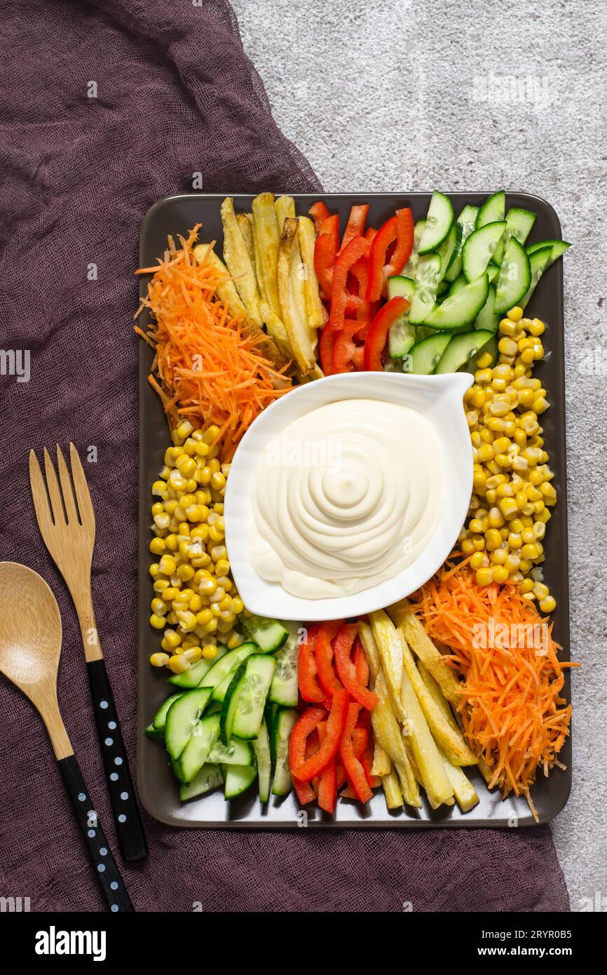 Homemade mayonnaise sauce. Dish with set of colorful vegetables ...