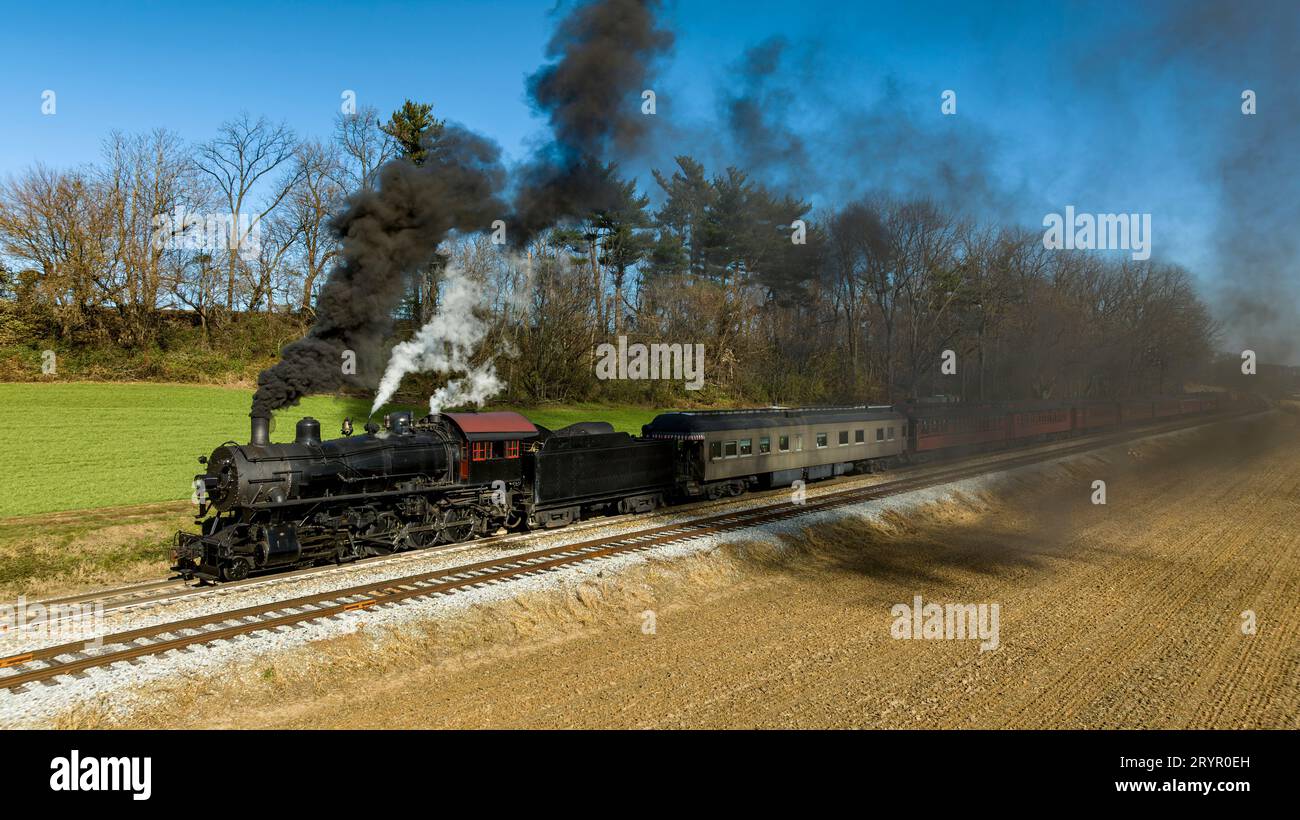 A Drone Side View of an Antique Steam Locomotive, and Passenger Coaches ...