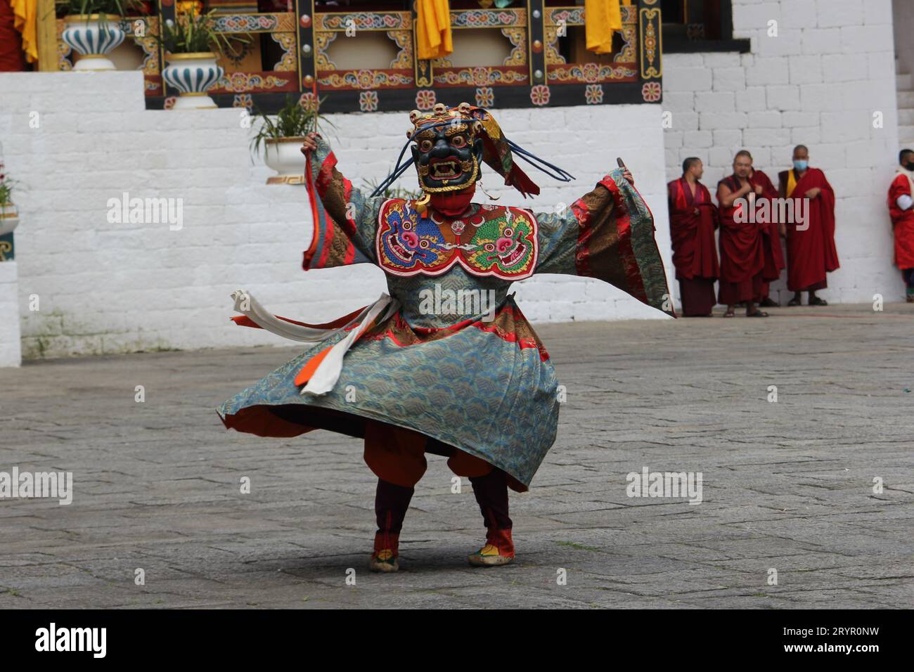 A cheerful group of diverse individuals, wearing vibrant outfits, are ...