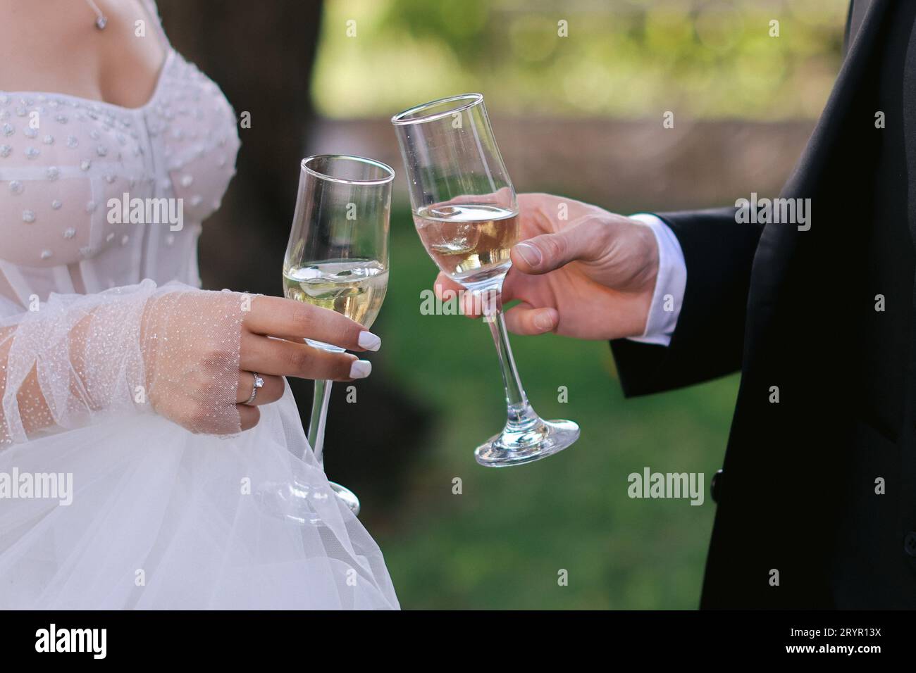 A newlywed couple celebrating their union with a toast of champagne ...