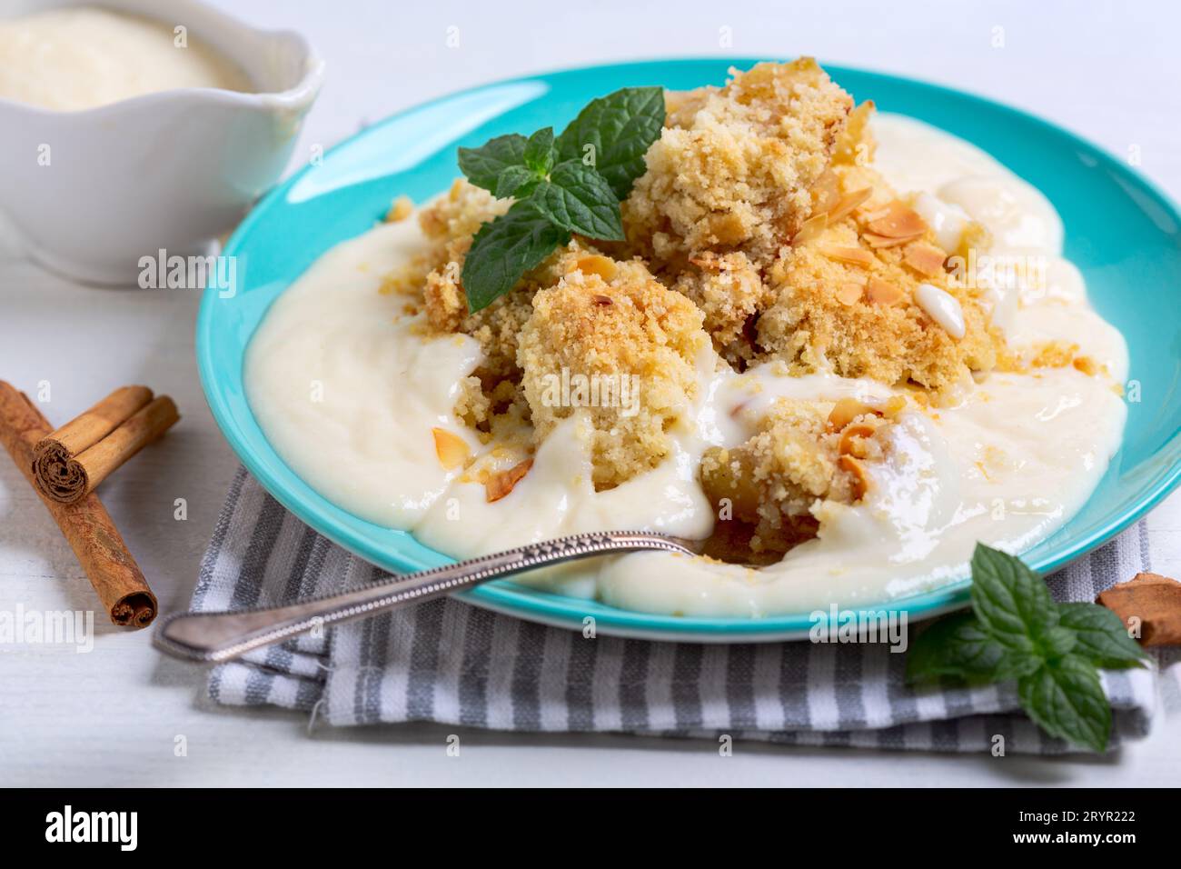 Apple crumble with custard Stock Photo - Alamy