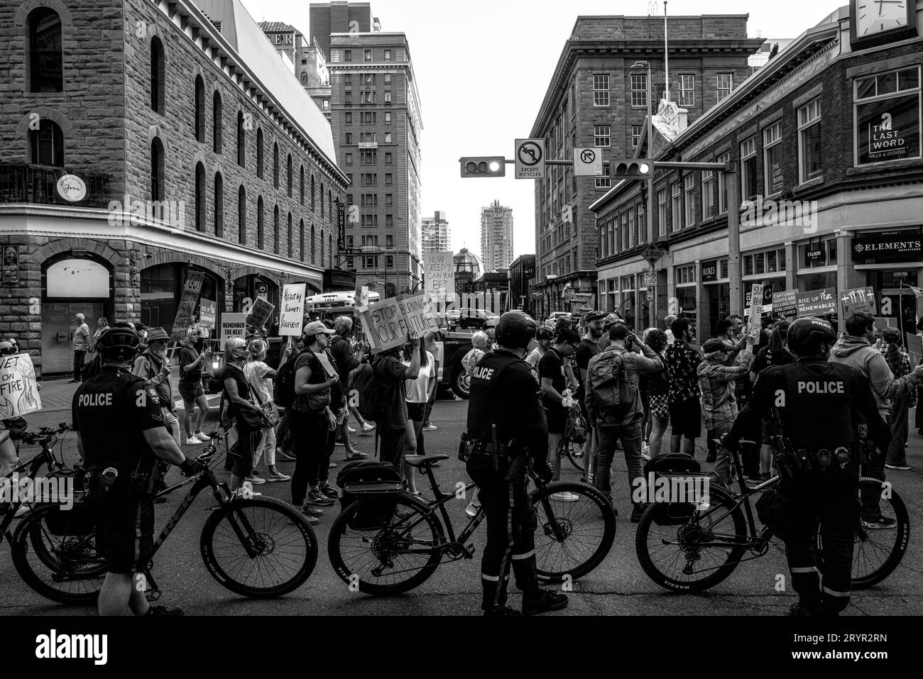 Black and white photograph of police officers blocking the road as ...